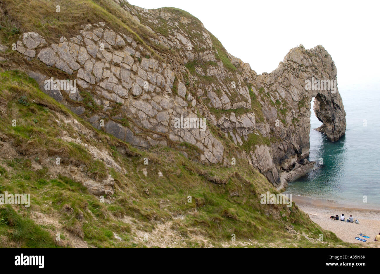 Durdle Door natural limestone arch and beach with holidaymakers in ...
