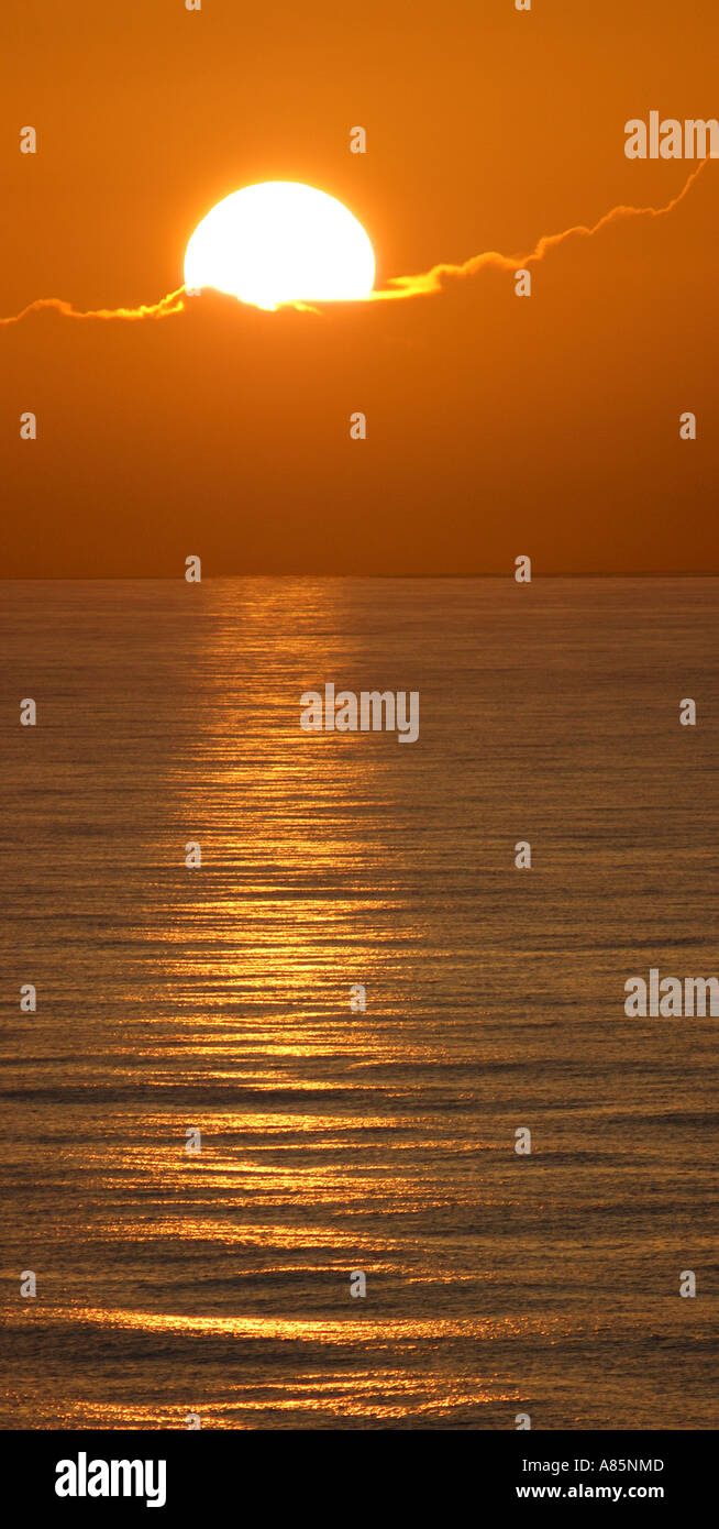 sun reflecting on the ocean surface at sunrise Stock Photo - Alamy