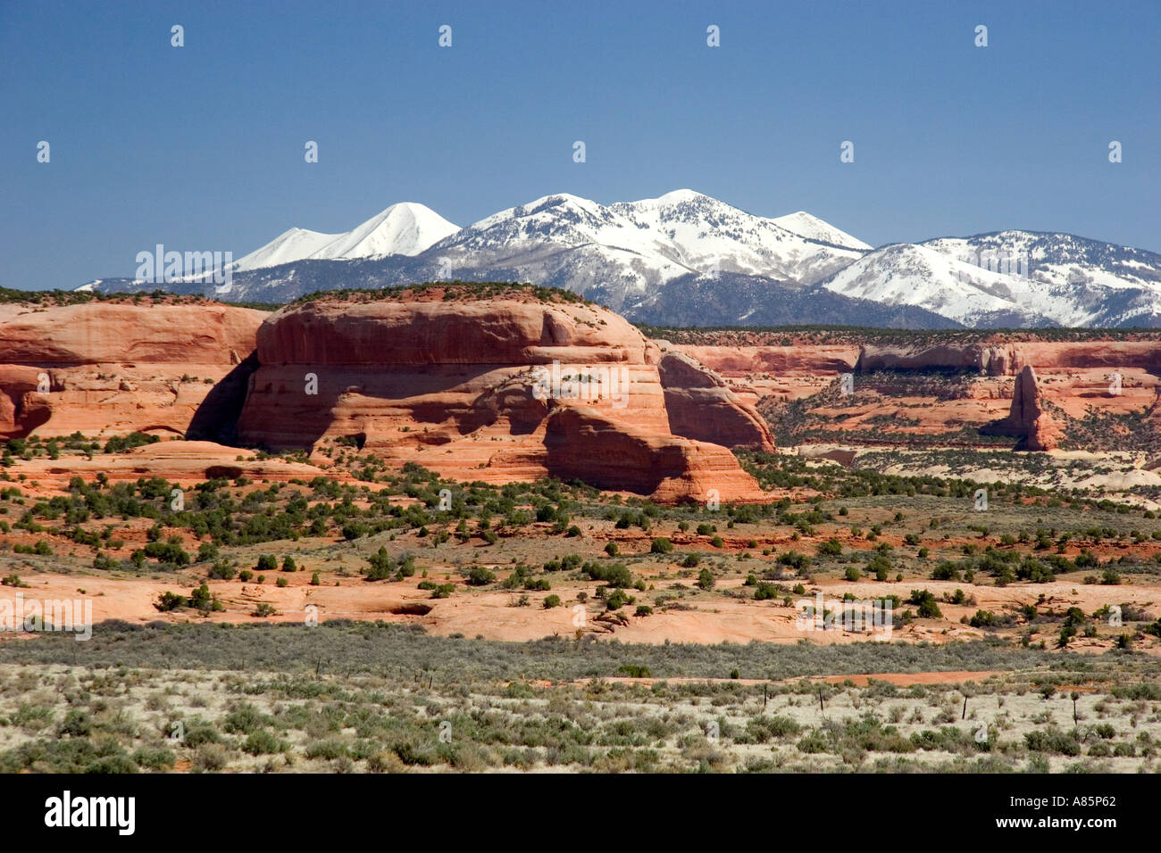 A view of snowy La Sal mountains and sandstone along US highway 191 ...