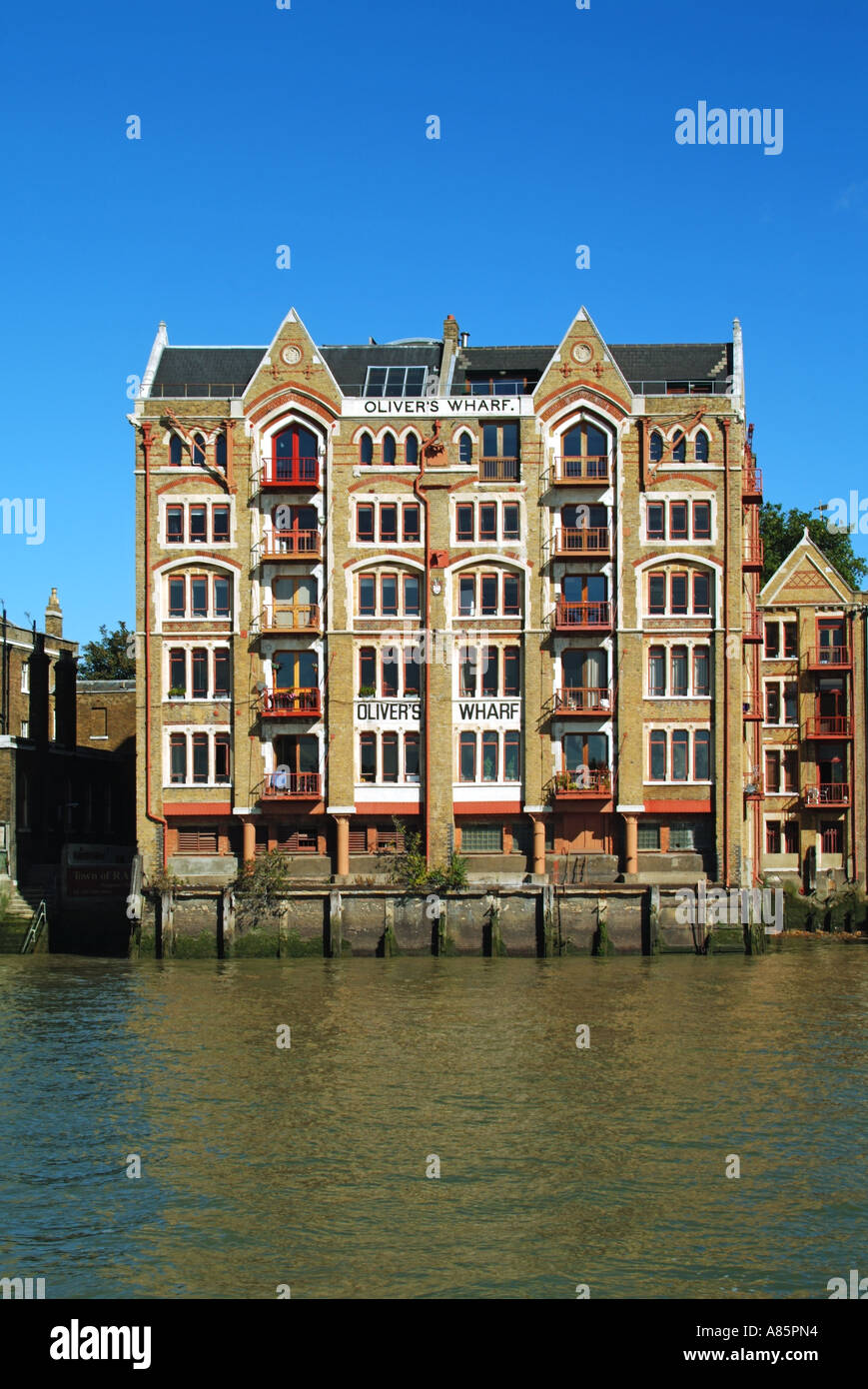 Olivers Wharf old waterside warehouse building beside the River Thames ...