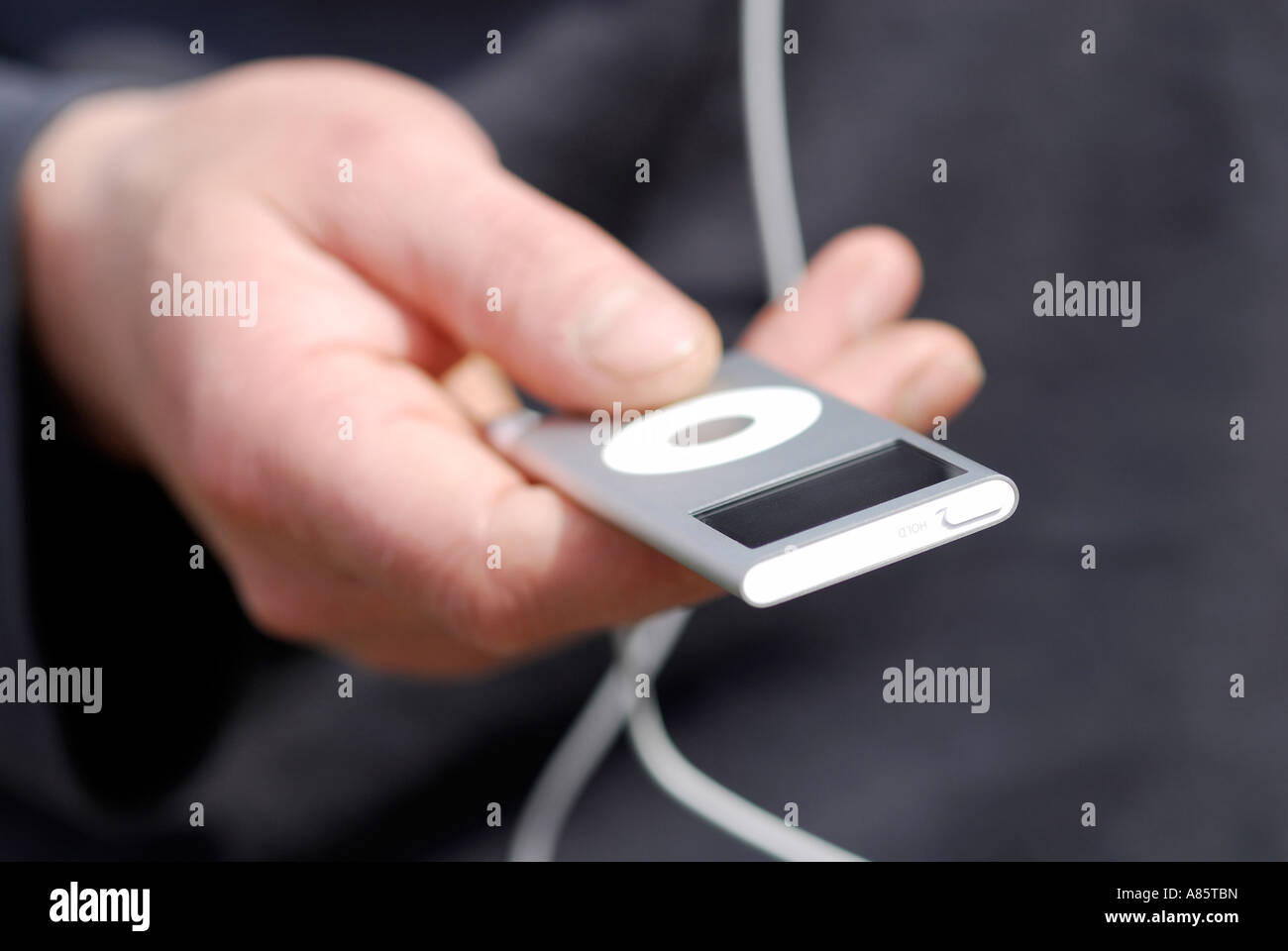 male hand holding mp3 player Stock Photo - Alamy