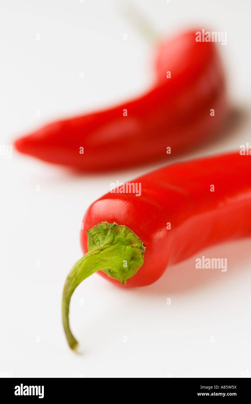 Two red Chilli Peppers on a white background Stock Photo - Alamy