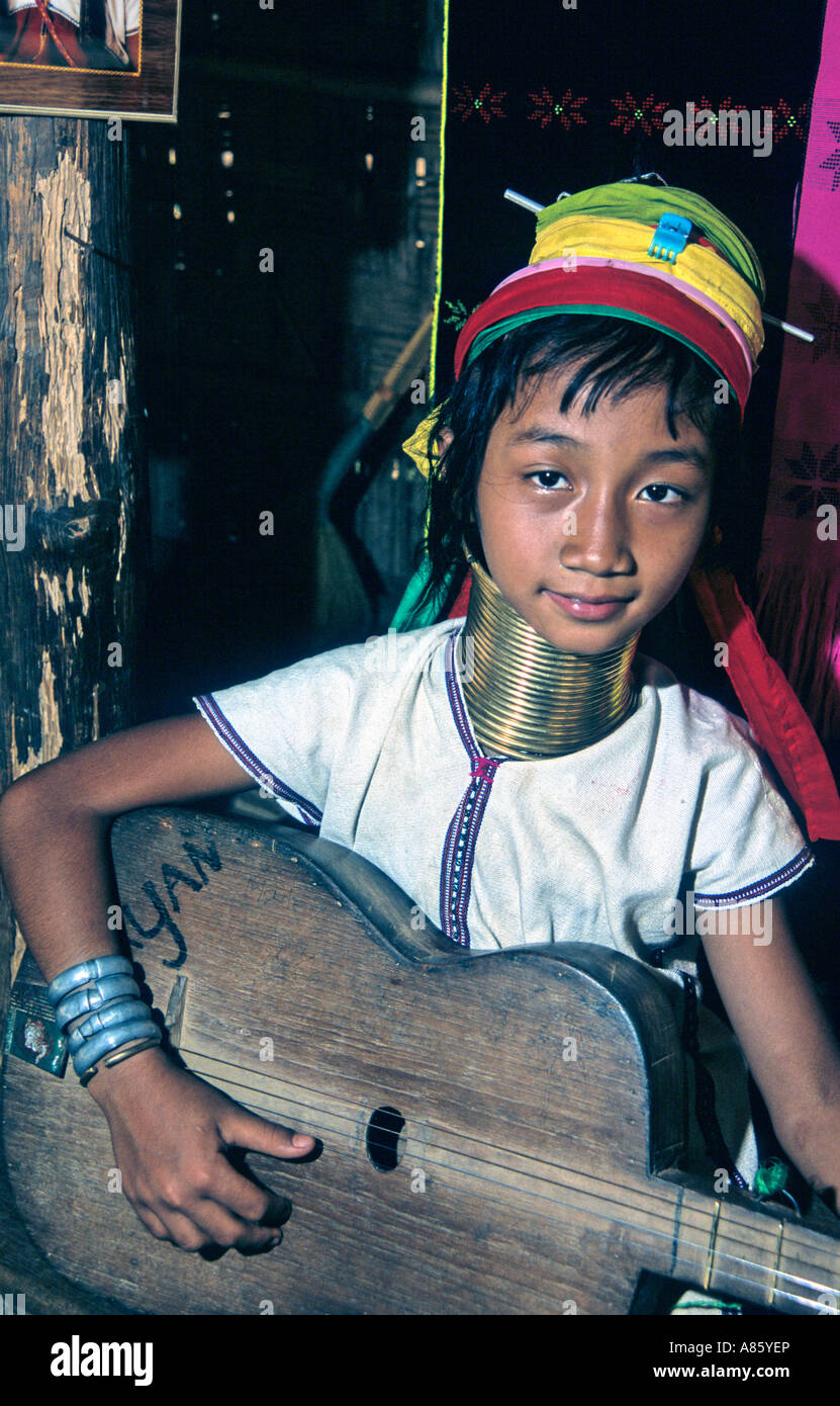 Long-necked girl of Padong tribe playing guitar. Refugee from Burma ...