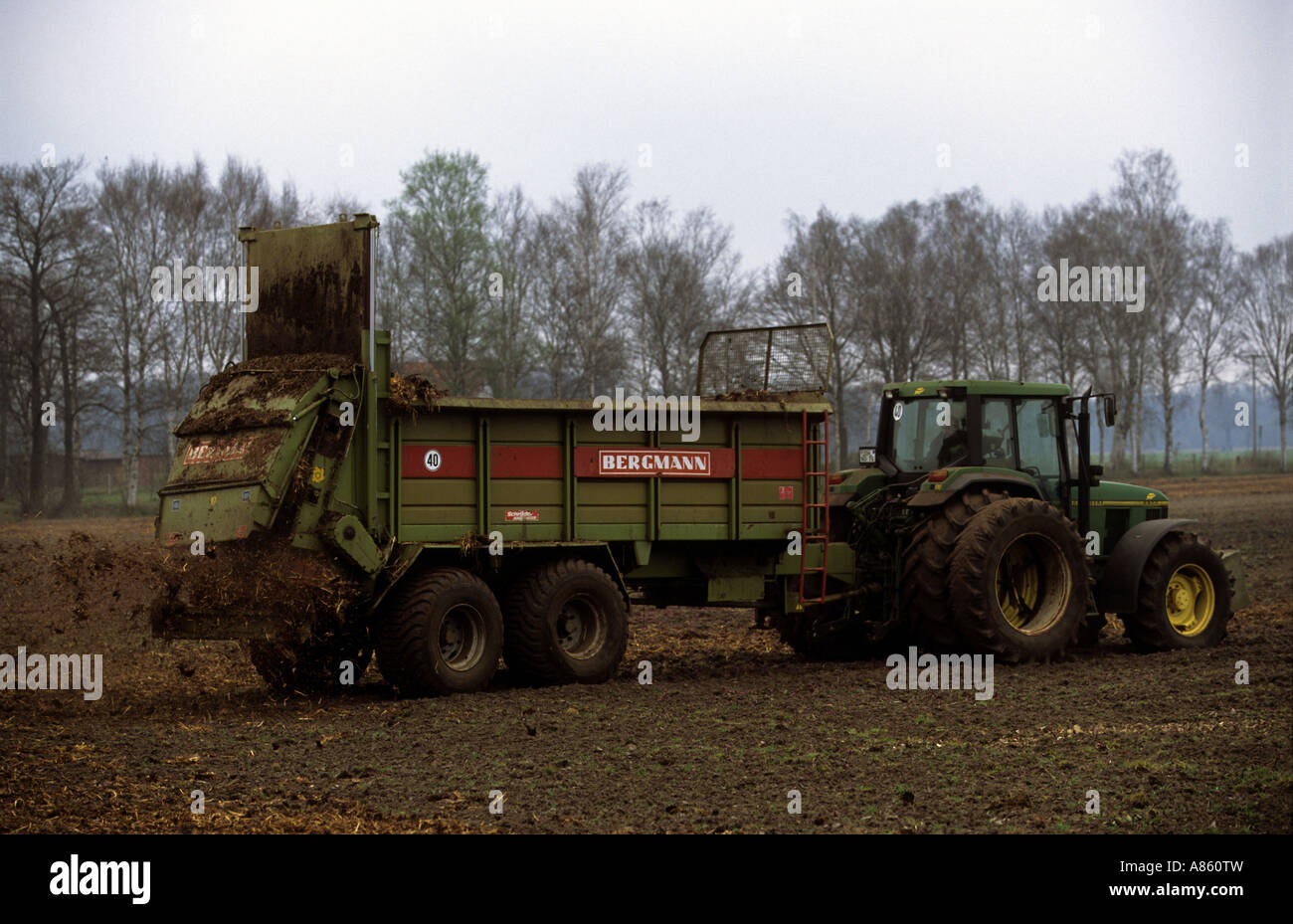 Farmer spreading muck on a farm in Strohen, Lower Saxony, Germany Stock ...