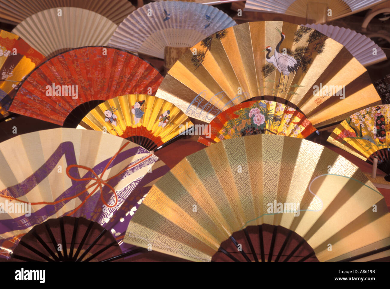 Collection of beautiful gold fans with traditional Japanese themes are ...