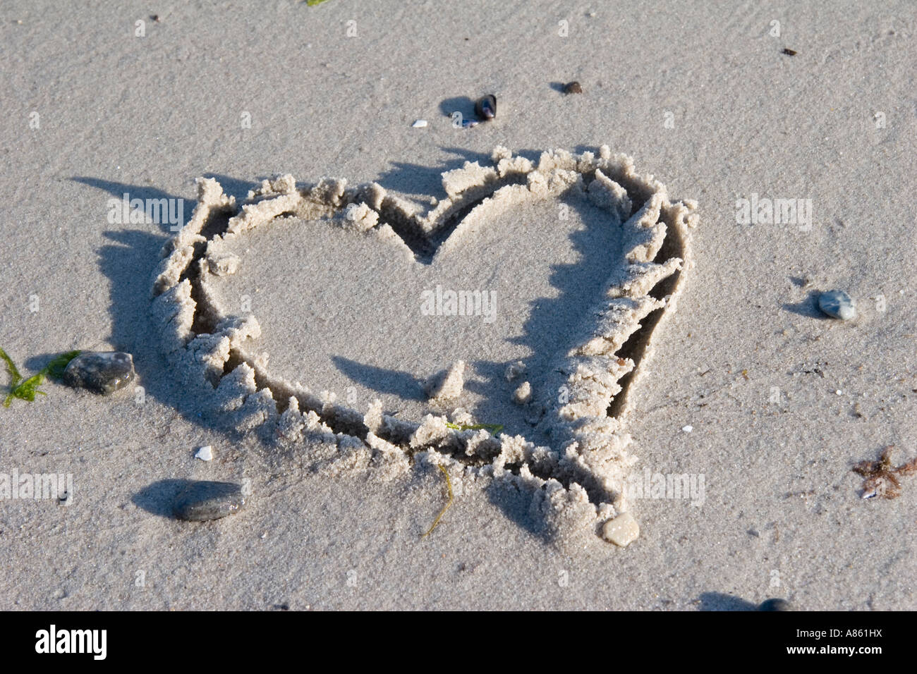HEART SHAPE PAINTED IN THE SAND ON THE BEACH Stock Photo - Alamy