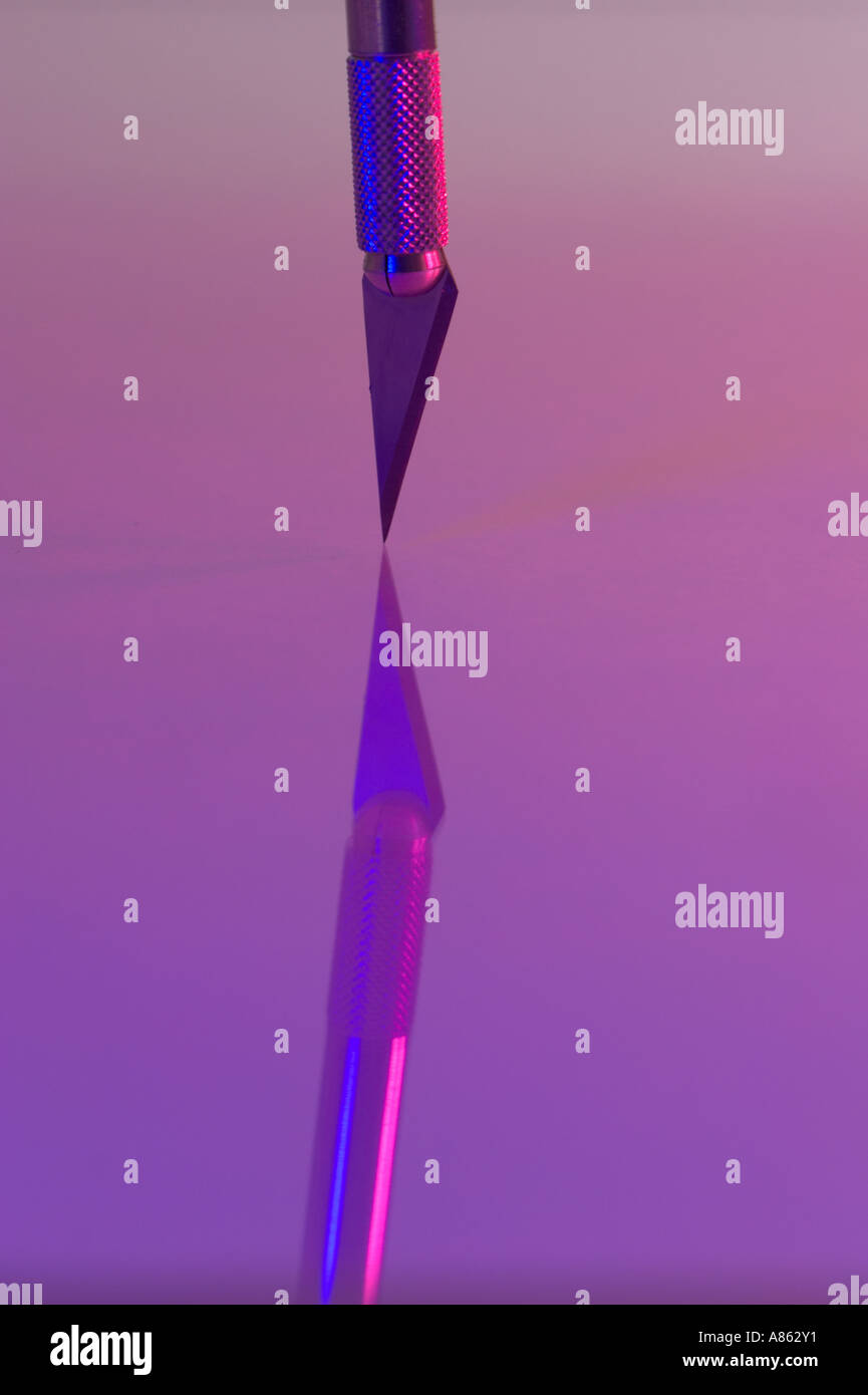 A knife with reflection in red, blue, and violet light Stock Photo - Alamy