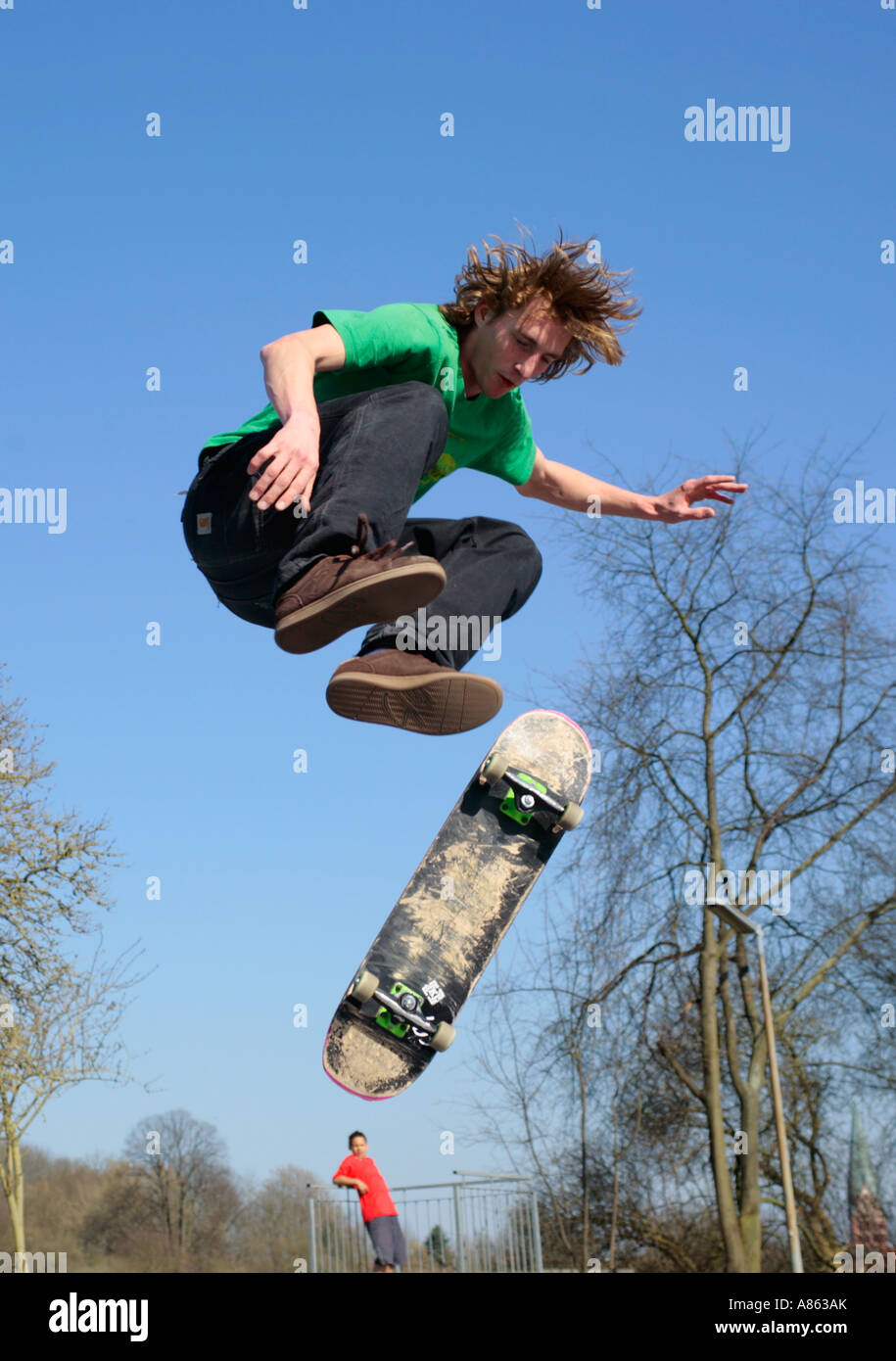 a young skater jumping with his skateboard Stock Photo - Alamy