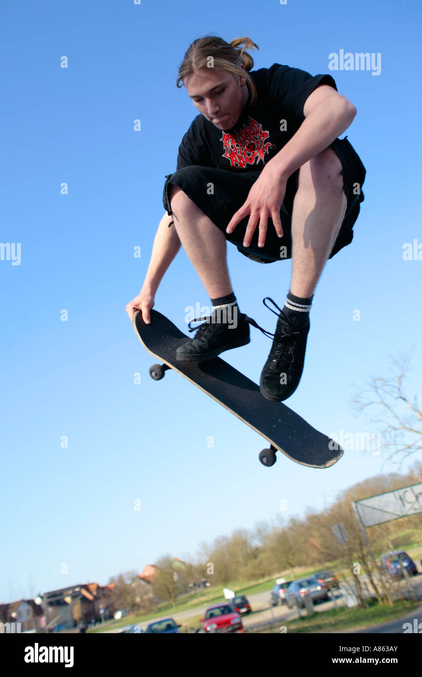 a young skater jumping with his skateboard Stock Photo - Alamy