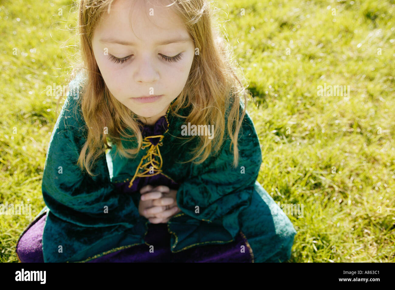 Child sitting alone in field portrait Stock Photo - Alamy
