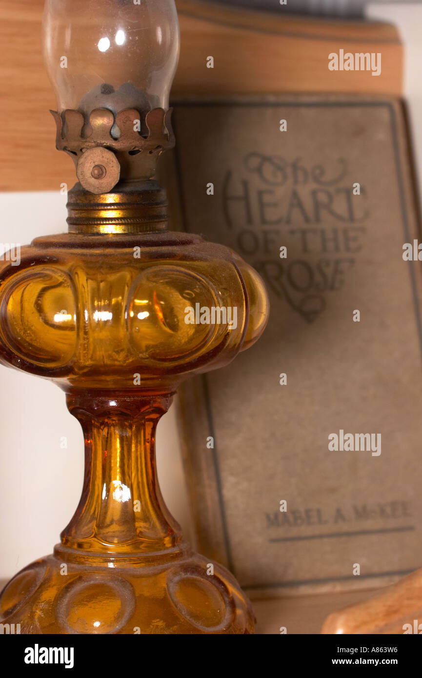 an antique oil lamp with an antique book Stock Photo - Alamy