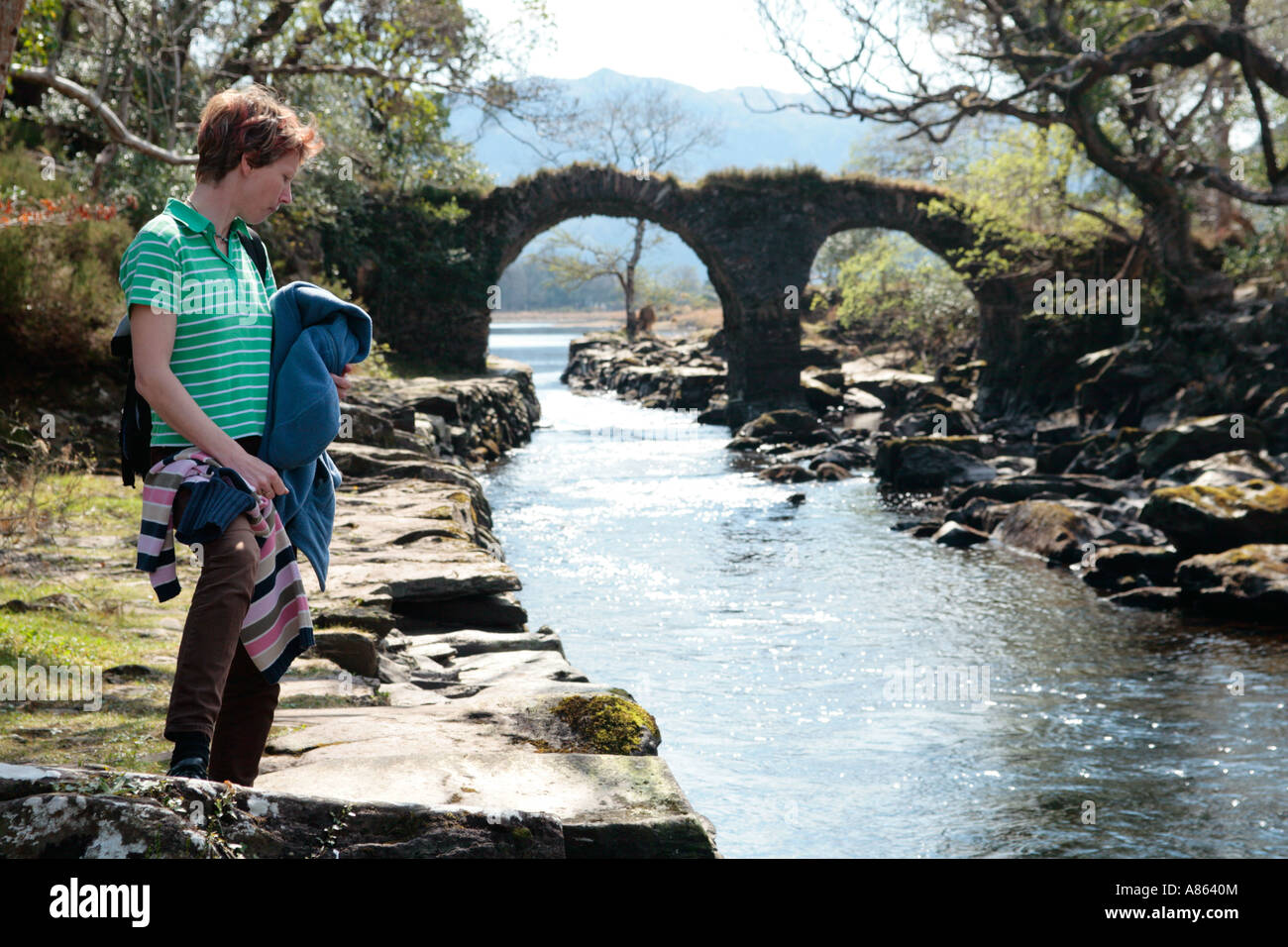 young woman visiting Old Weir Bridge at Killarney Nationalpark in ...