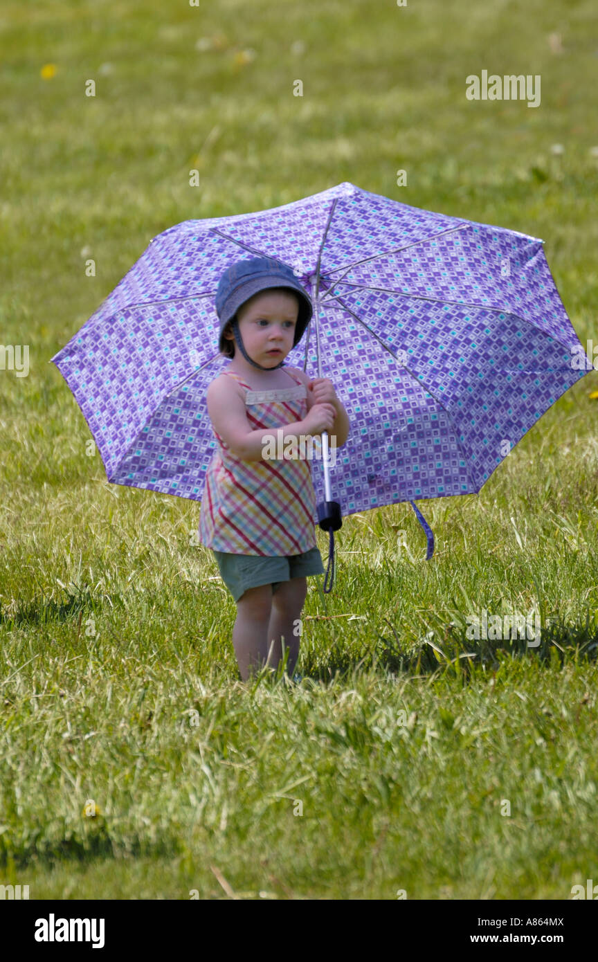 Young girl holding an umbrella at the International Kite and Culture ...