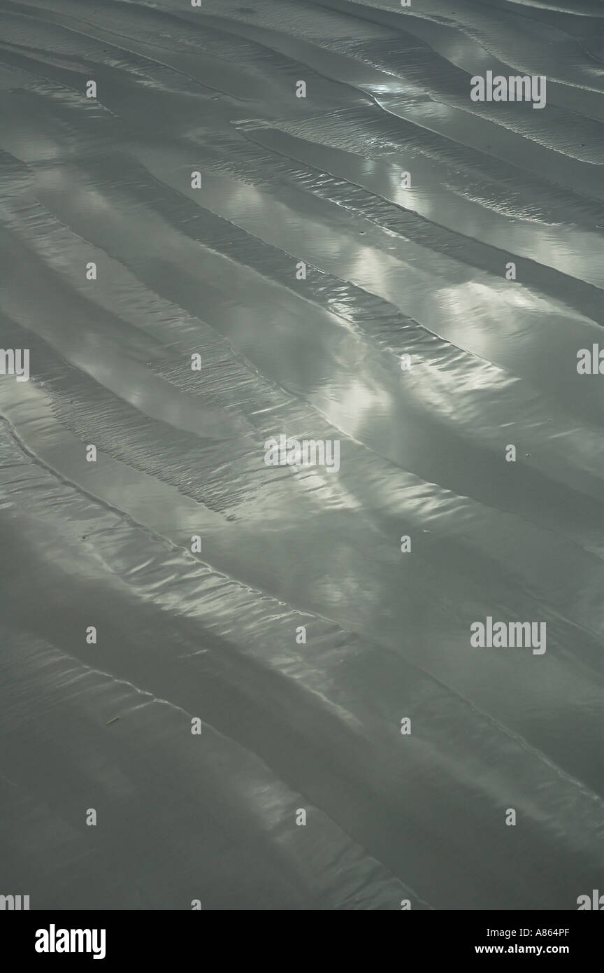 White sand ripples at the beach on a cloudy day Stock Photo - Alamy