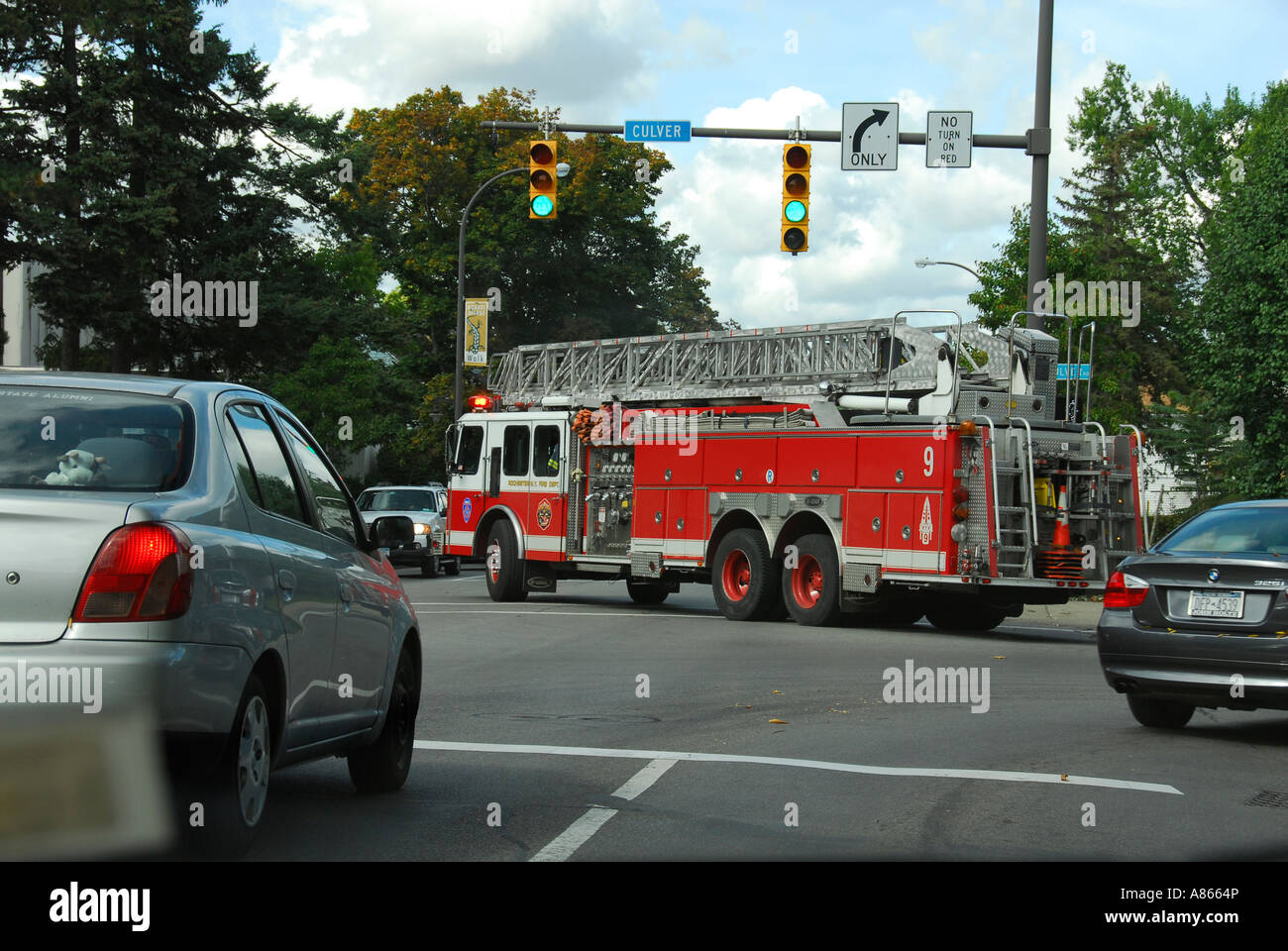 Fire truck crossing intersection Stock Photo - Alamy