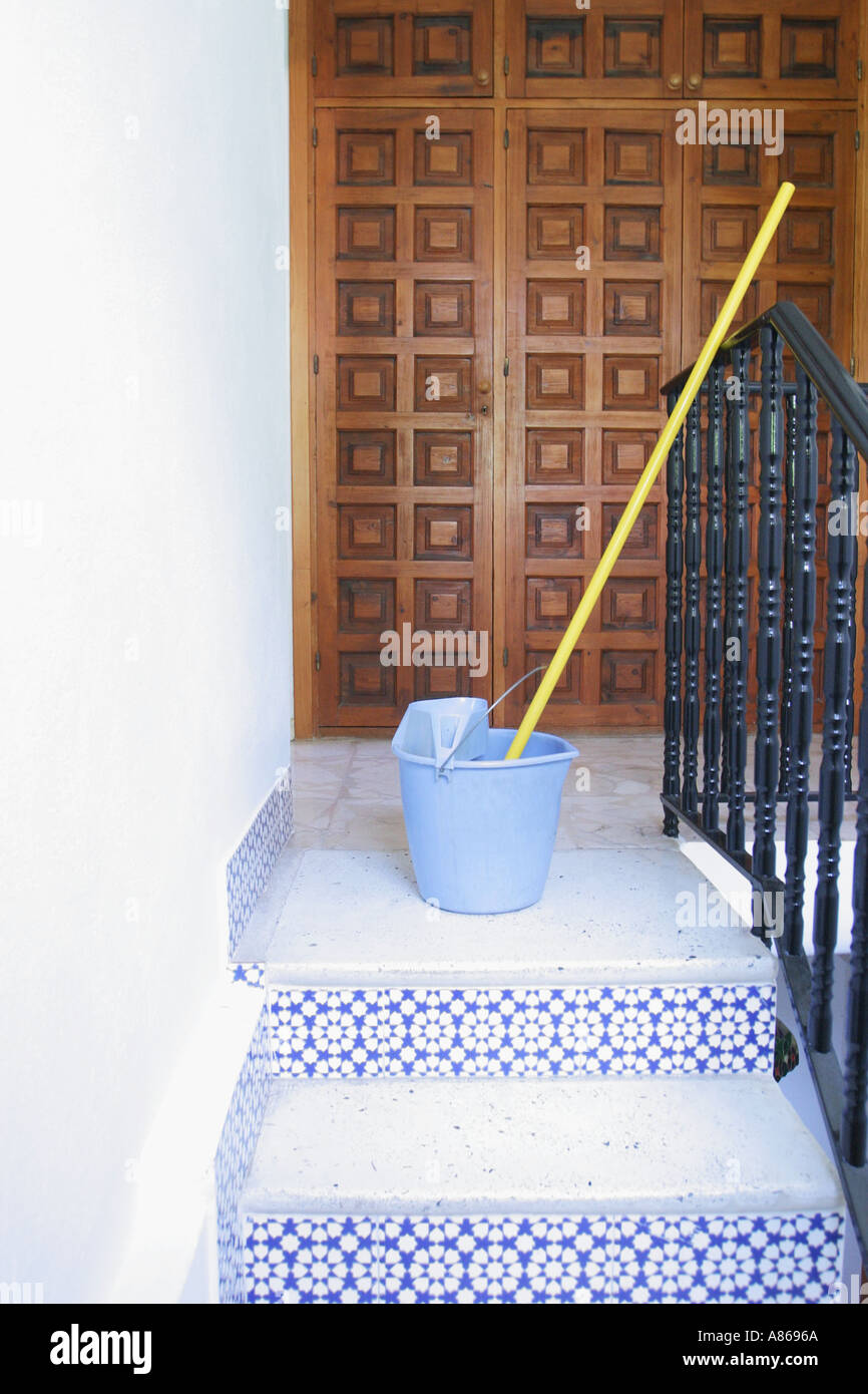 Bucket and mop on stairs Stock Photo - Alamy