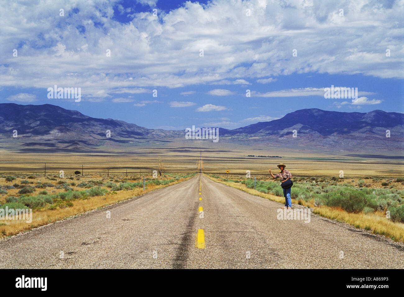 Hitch hiker on Highway 93 crossing the endless Nevada desert USA Stock ...