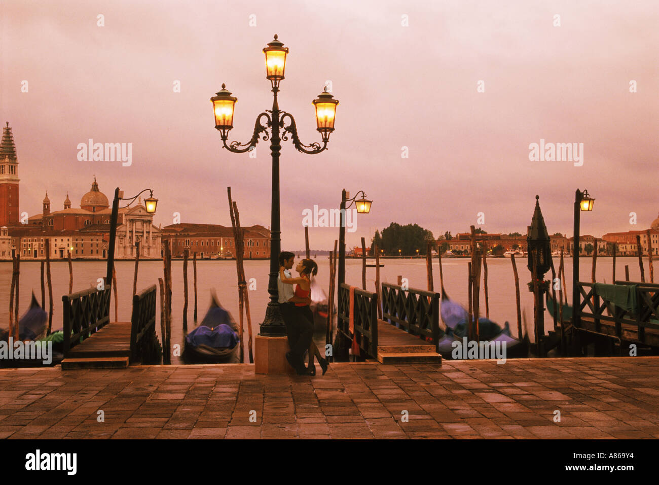 Woman leaning against lamp post hi-res stock photography and images - Alamy