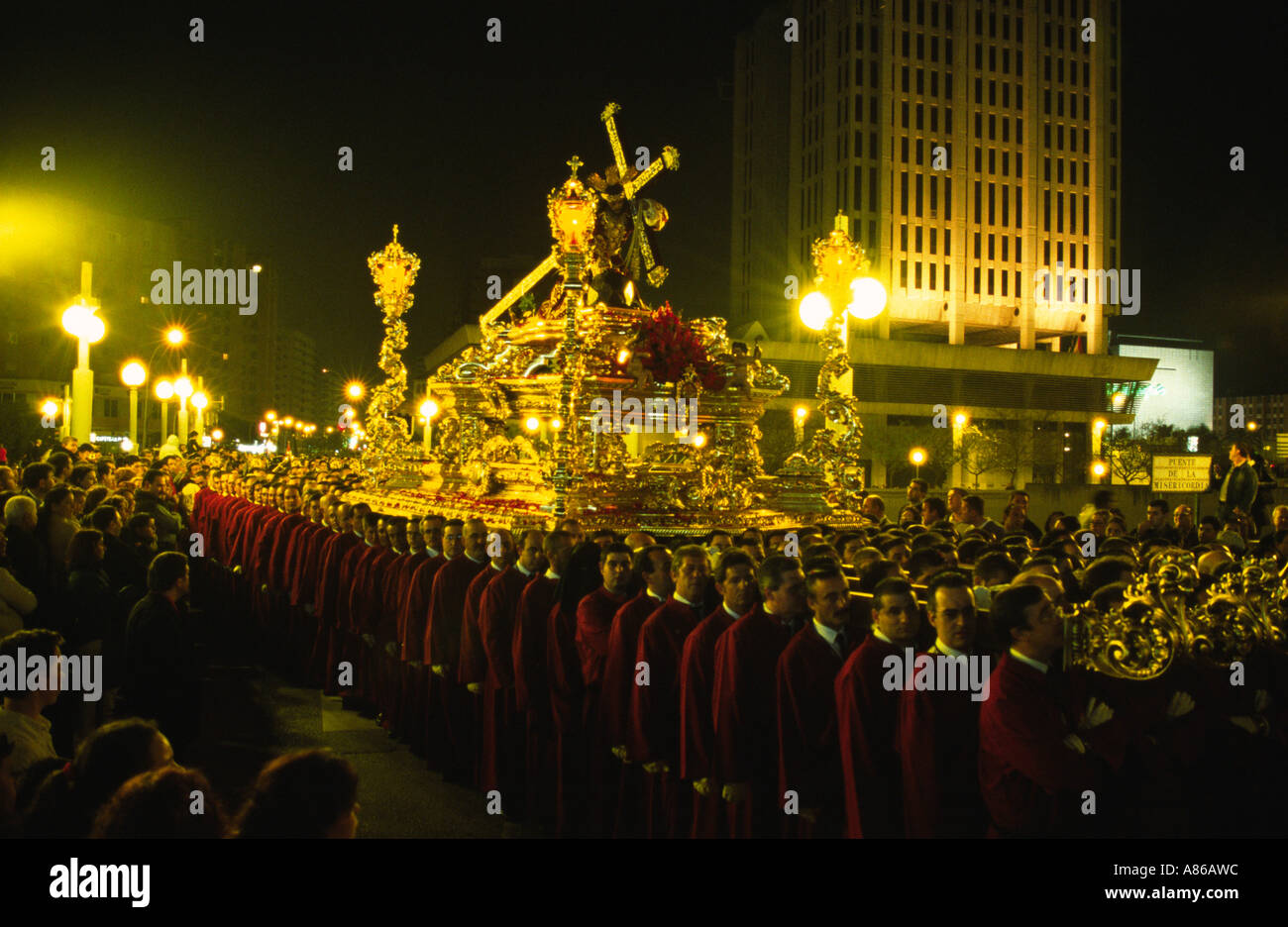 Easter procession in Spain Brotherhood in red carries a paso with ...