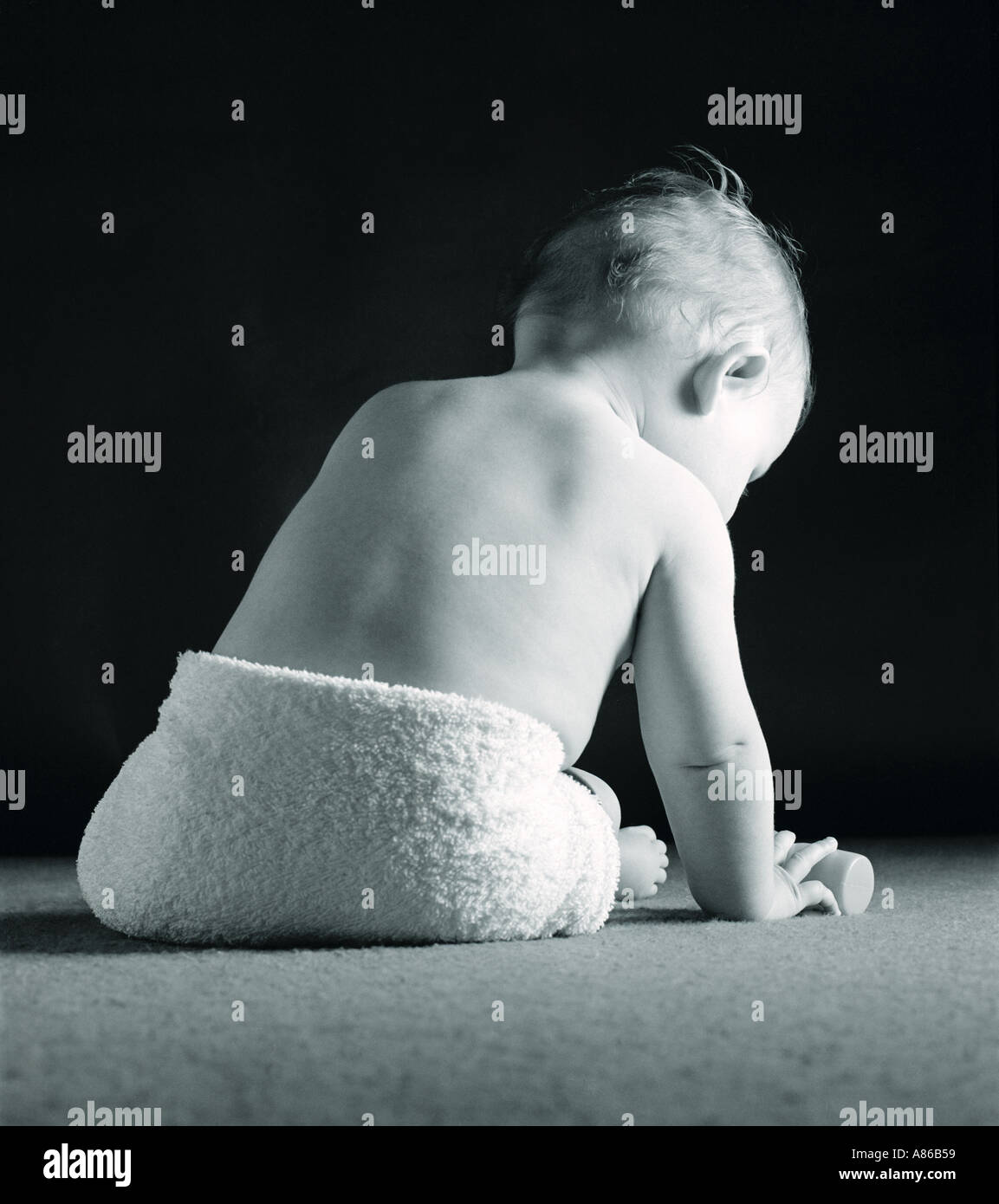 Baby in nappy with back to viewer Stock Photo - Alamy