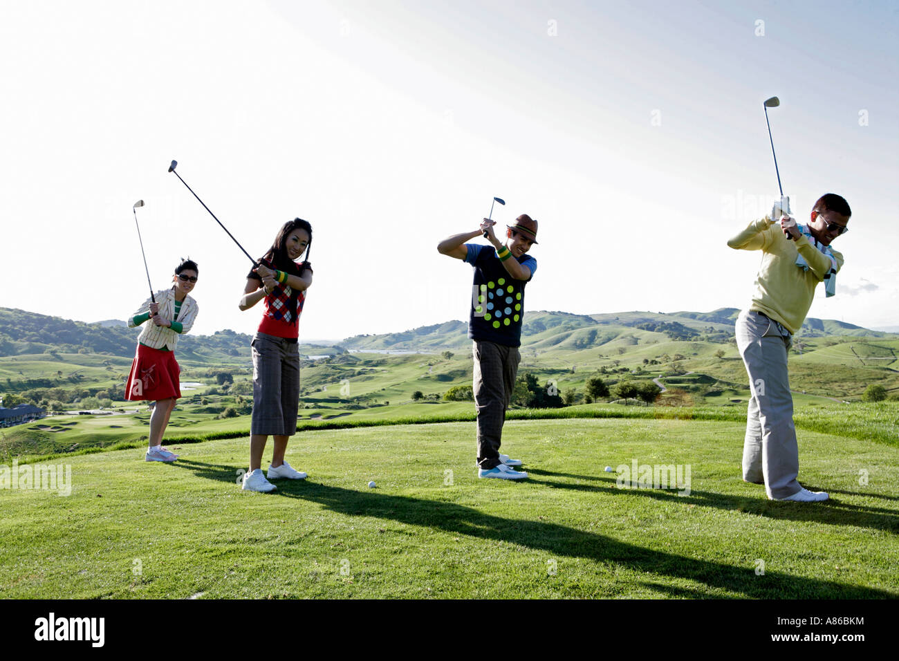 View of people golfing on a pleasant day Stock Photo - Alamy