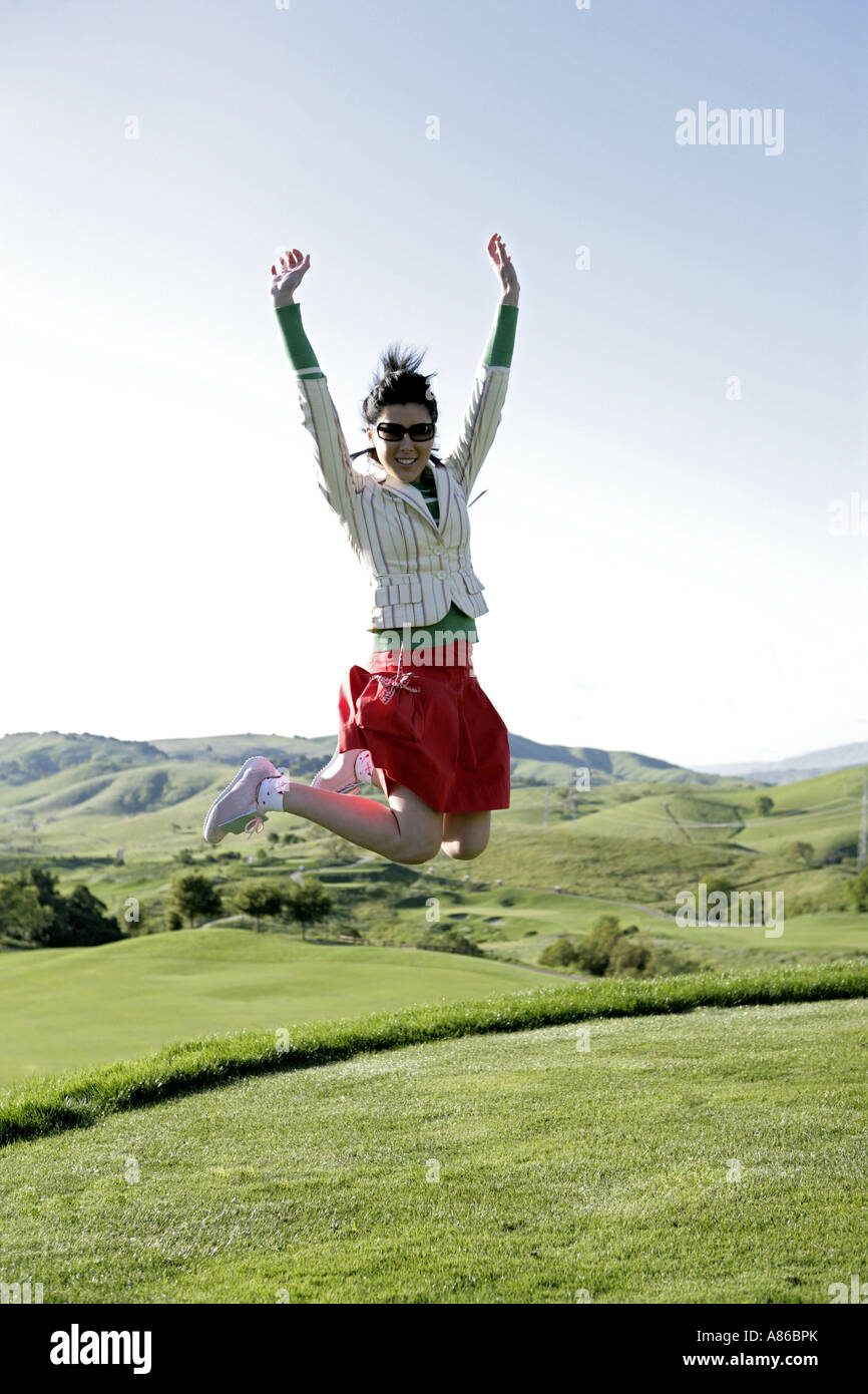 Happy sporty woman jumping hi-res stock photography and images - Alamy