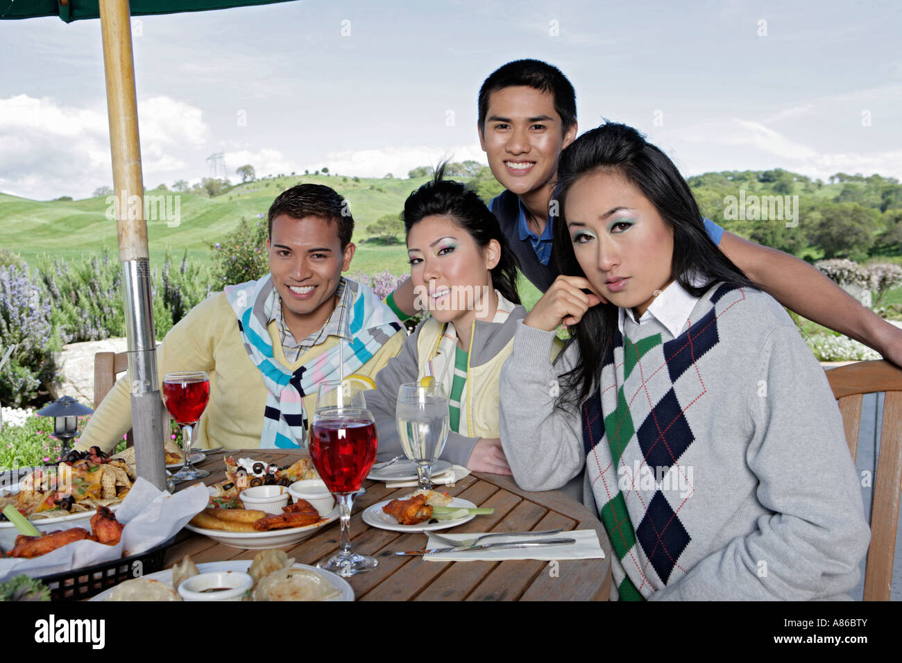 Four people looking at camera Stock Photo - Alamy