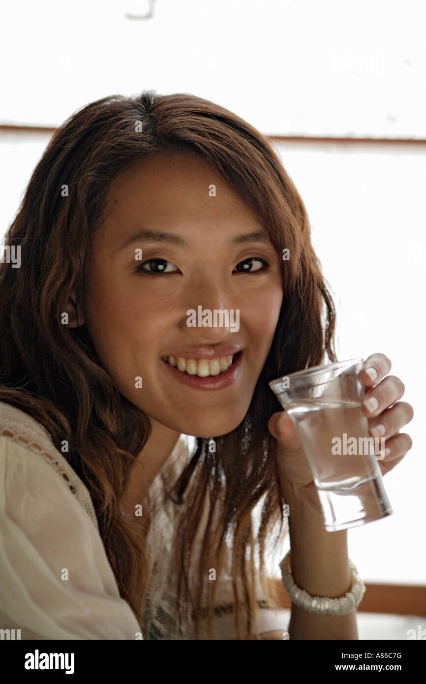 Young woman drinking, portrait Stock Photo - Alamy
