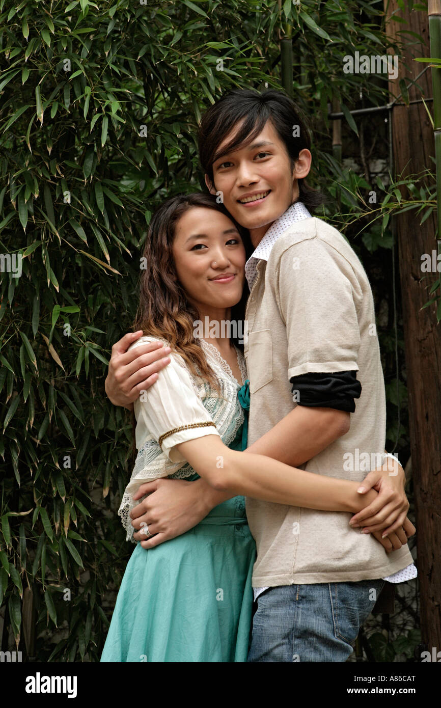 Young couple embracing, side view Stock Photo - Alamy