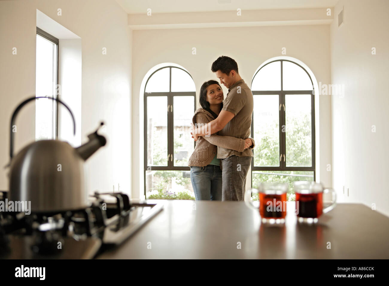 Two people embracing, side view Stock Photo - Alamy