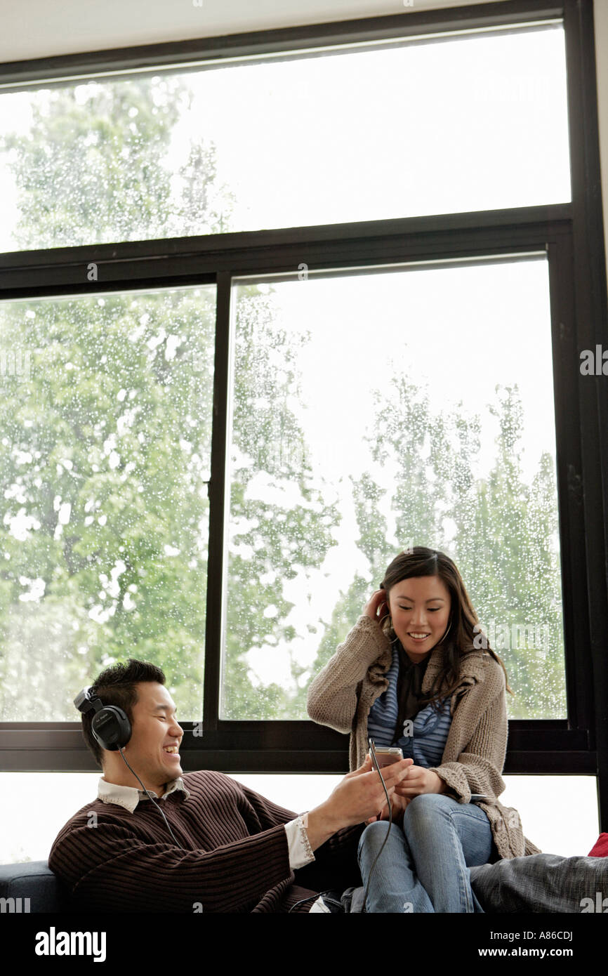 Two people sitting inside room, front view Stock Photo - Alamy
