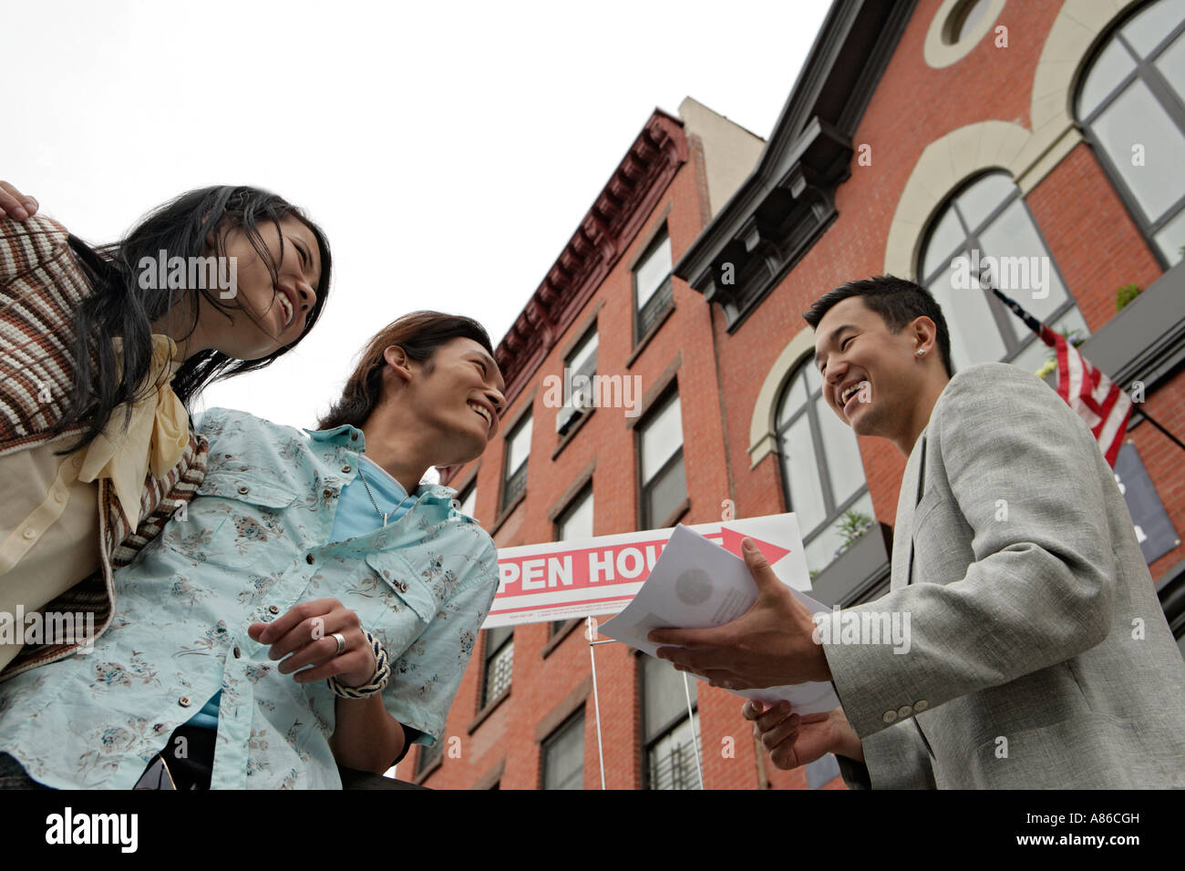 Three people engaged in conversation, low angle view Stock Photo - Alamy