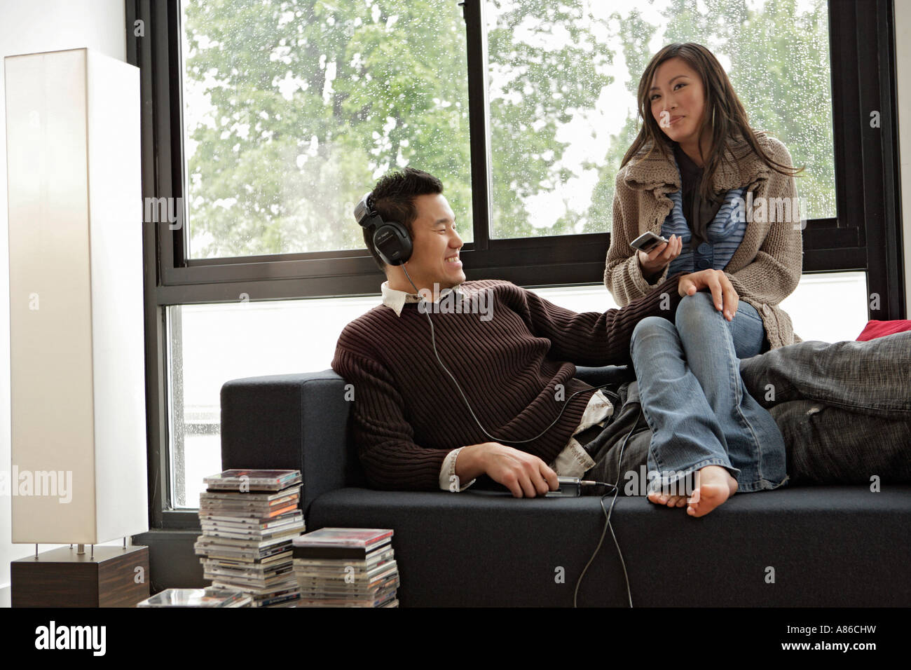 Couple with headphone and compact discs Stock Photo - Alamy