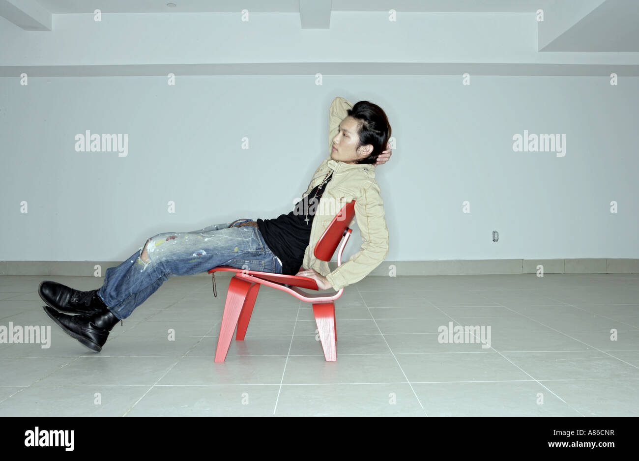 Man seated on chair, full length Stock Photo - Alamy