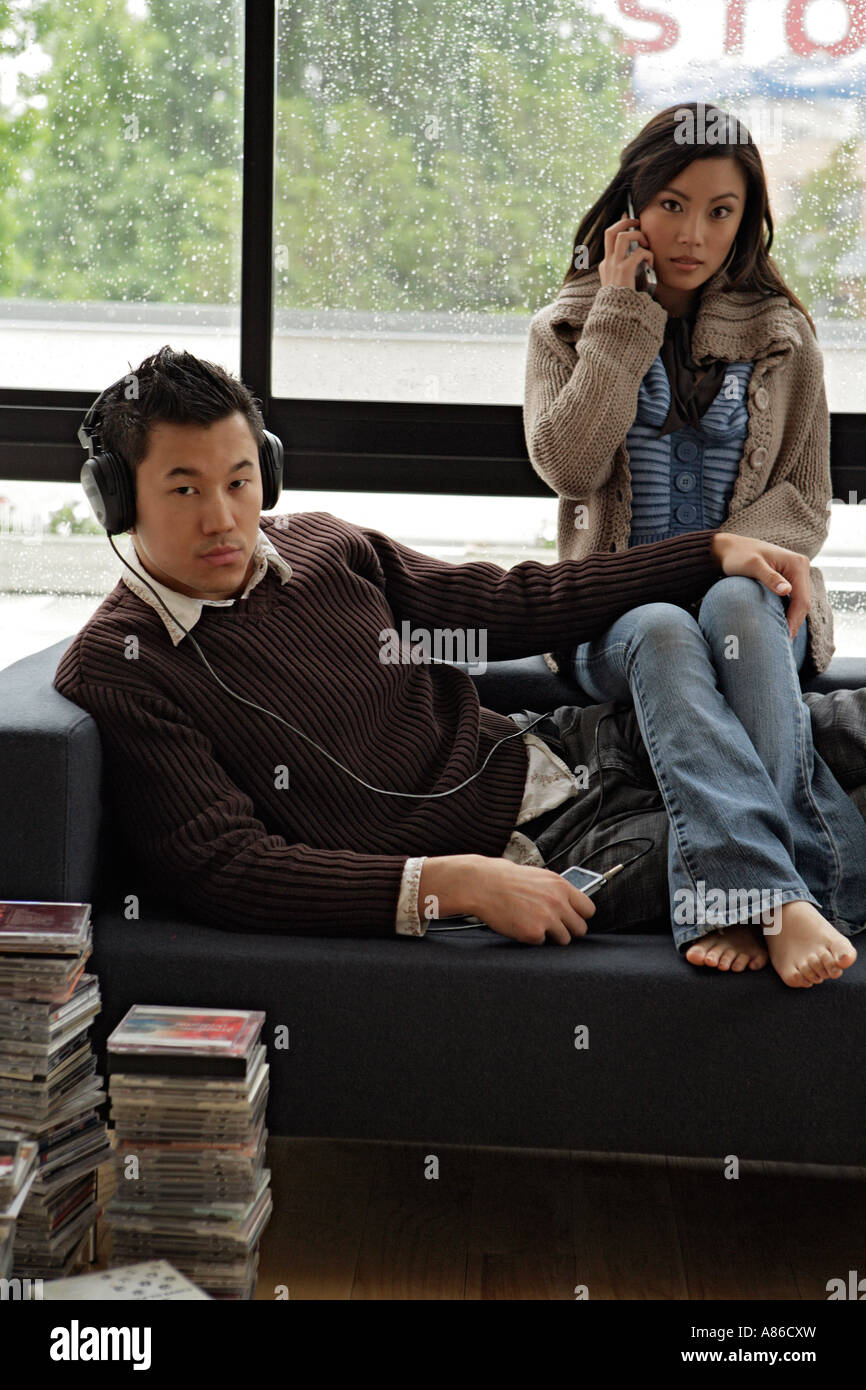 Two people sitting inside room, front view Stock Photo - Alamy