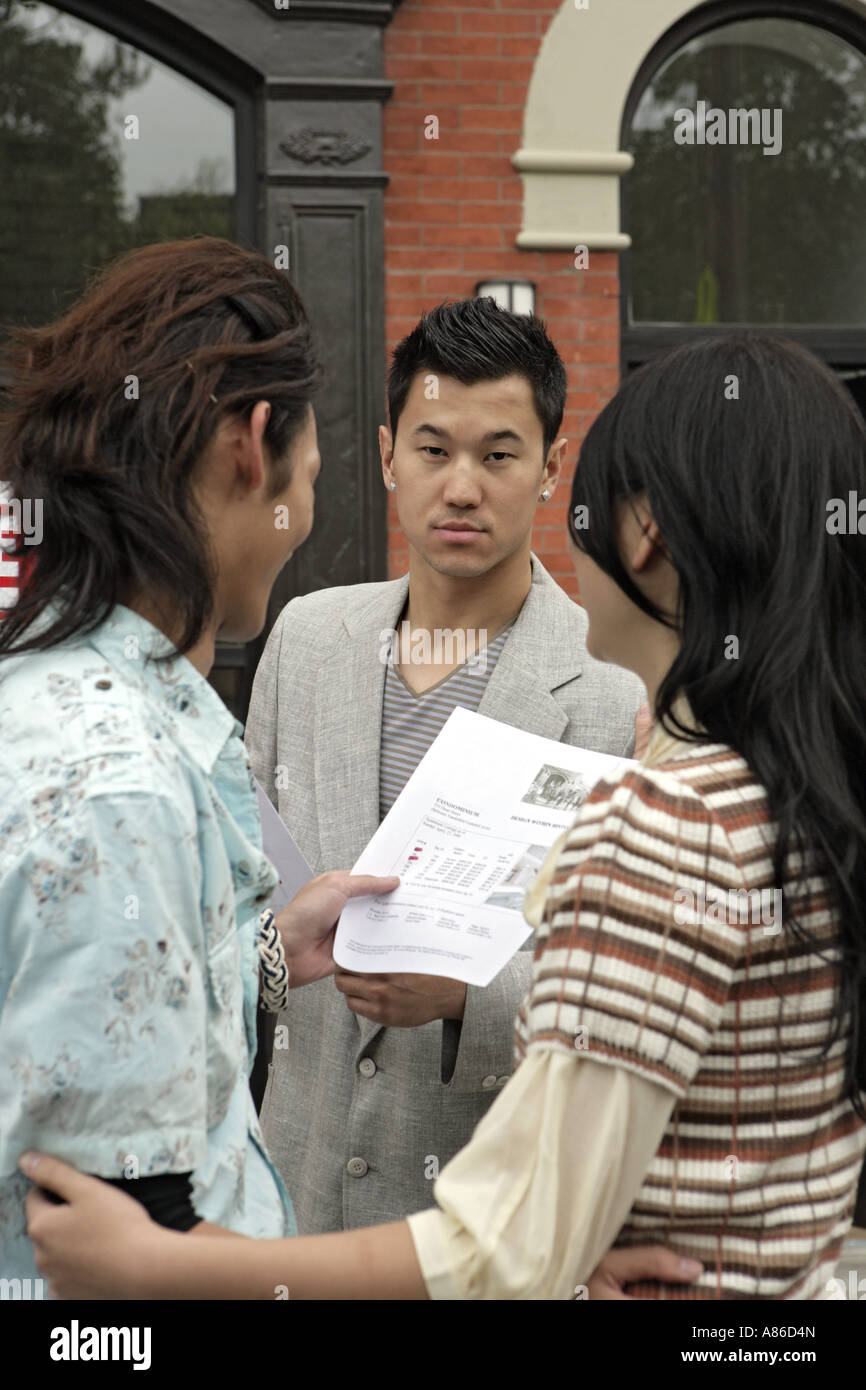 Young couple looking at document Stock Photo - Alamy