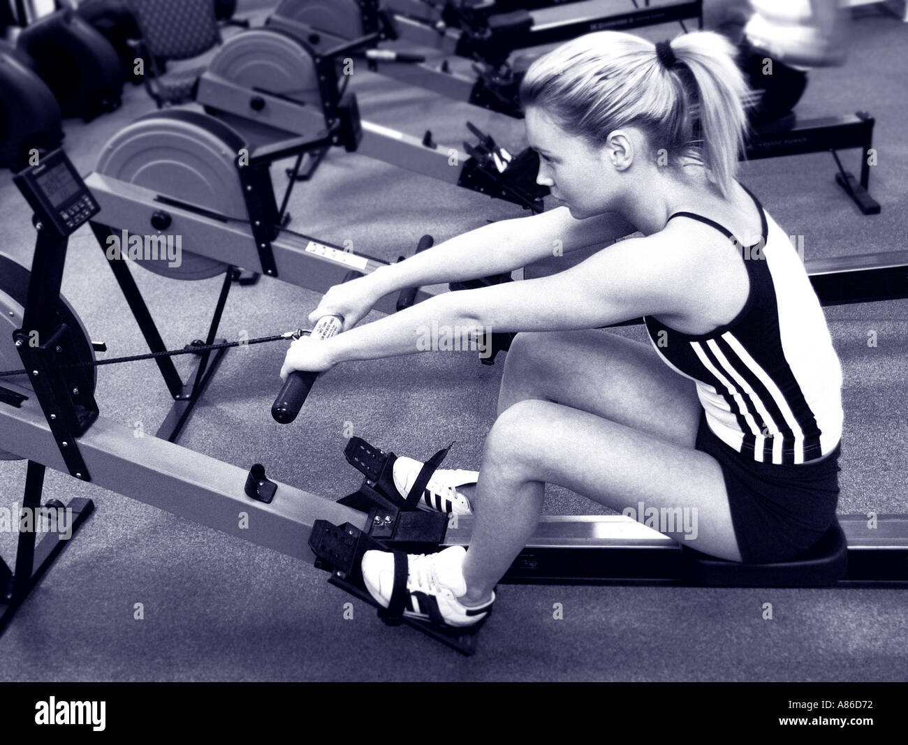 girl using rowing machine Stock Photo - Alamy