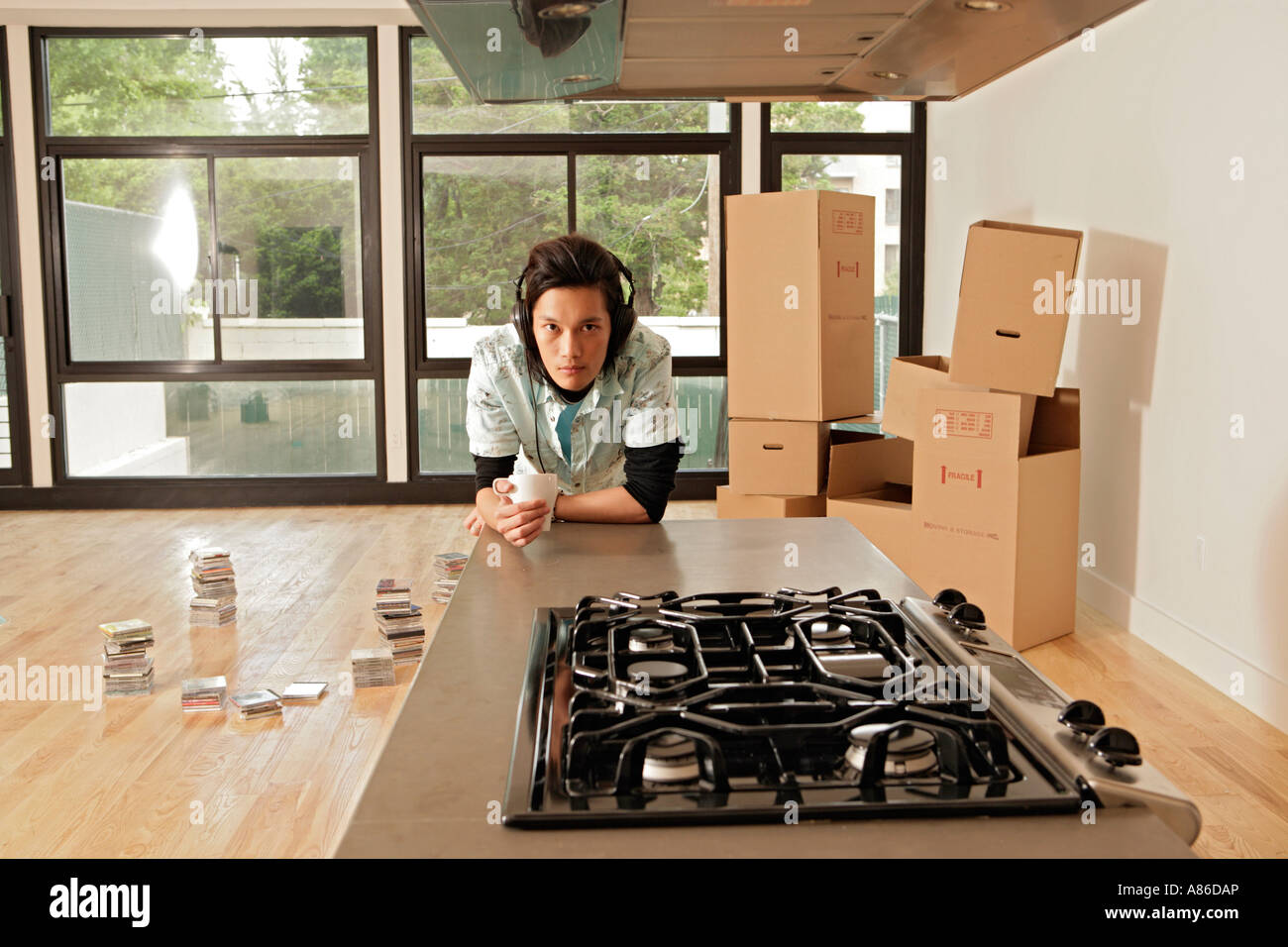 A young man leaning against table Stock Photo - Alamy