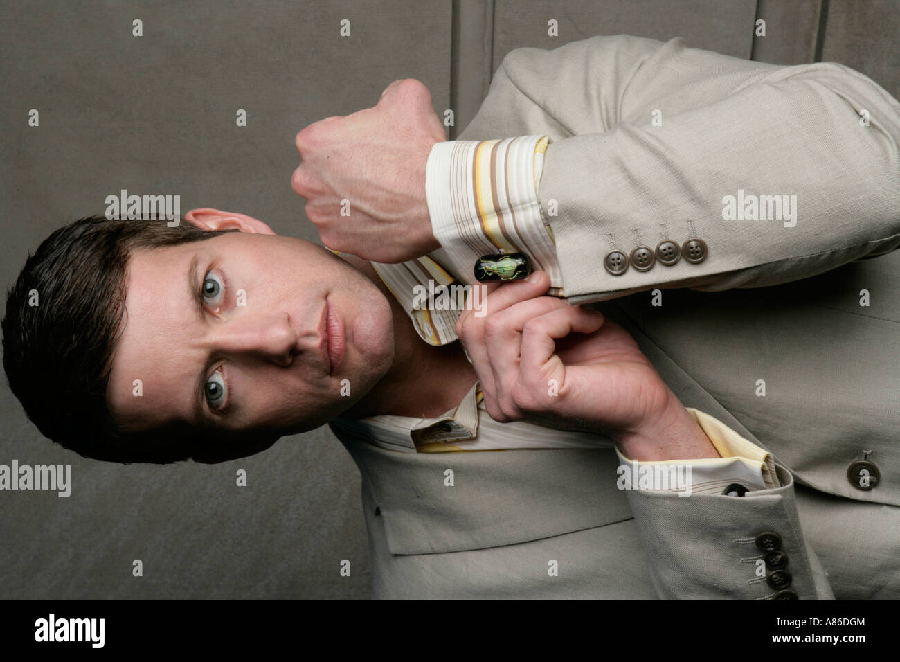 Caucasian man adjusting his cufflink Stock Photo - Alamy