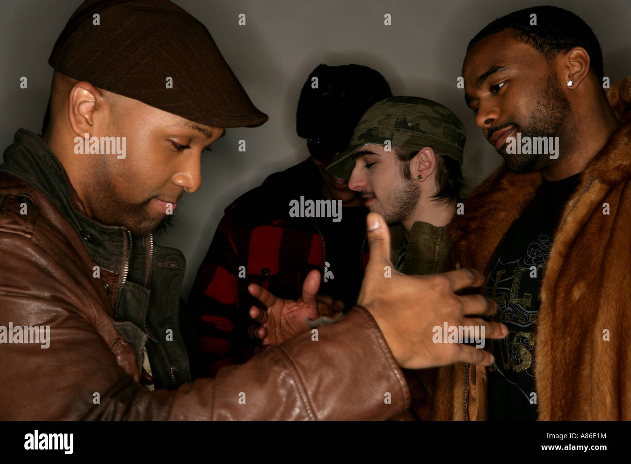 Four young men greeting each other Stock Photo - Alamy