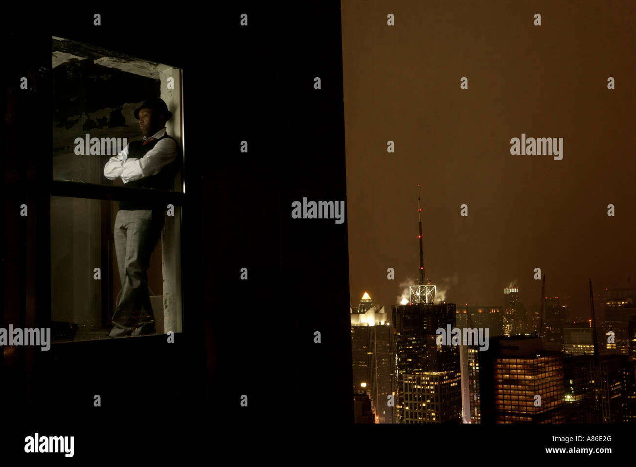 Young man leaning against a window Stock Photo - Alamy