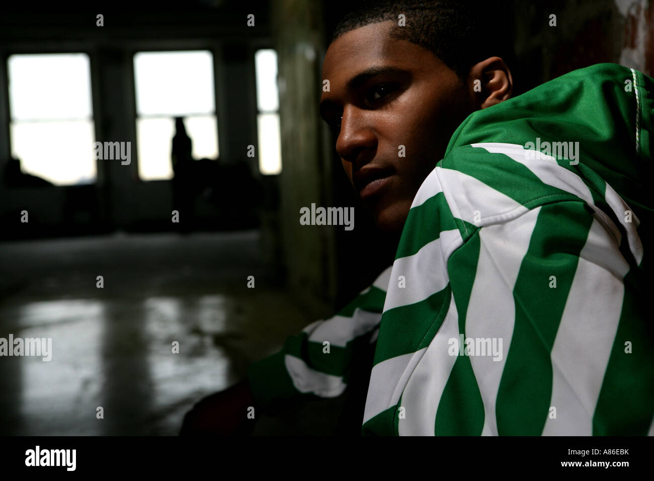 Person wearing hoodie sitting hi-res stock photography and images - Alamy