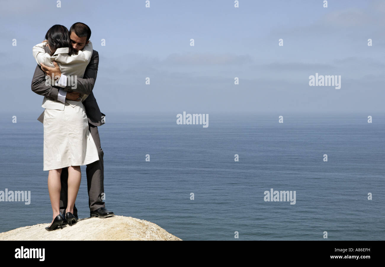View of a couple hugging each other on a cliff Stock Photo - Alamy