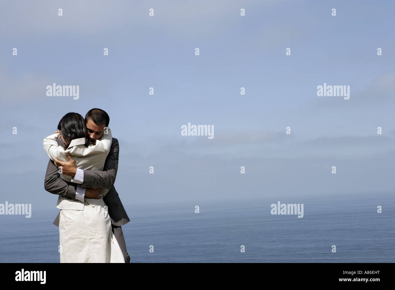 View of a couple hugging each other on a cliff Stock Photo - Alamy