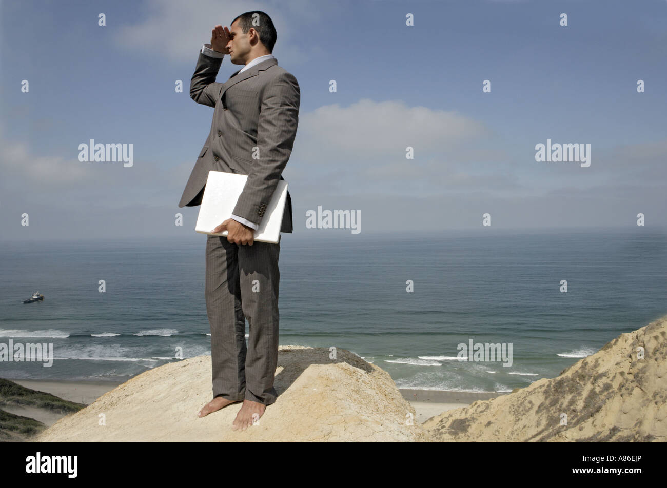 View of a man standing on a cliff Stock Photo - Alamy