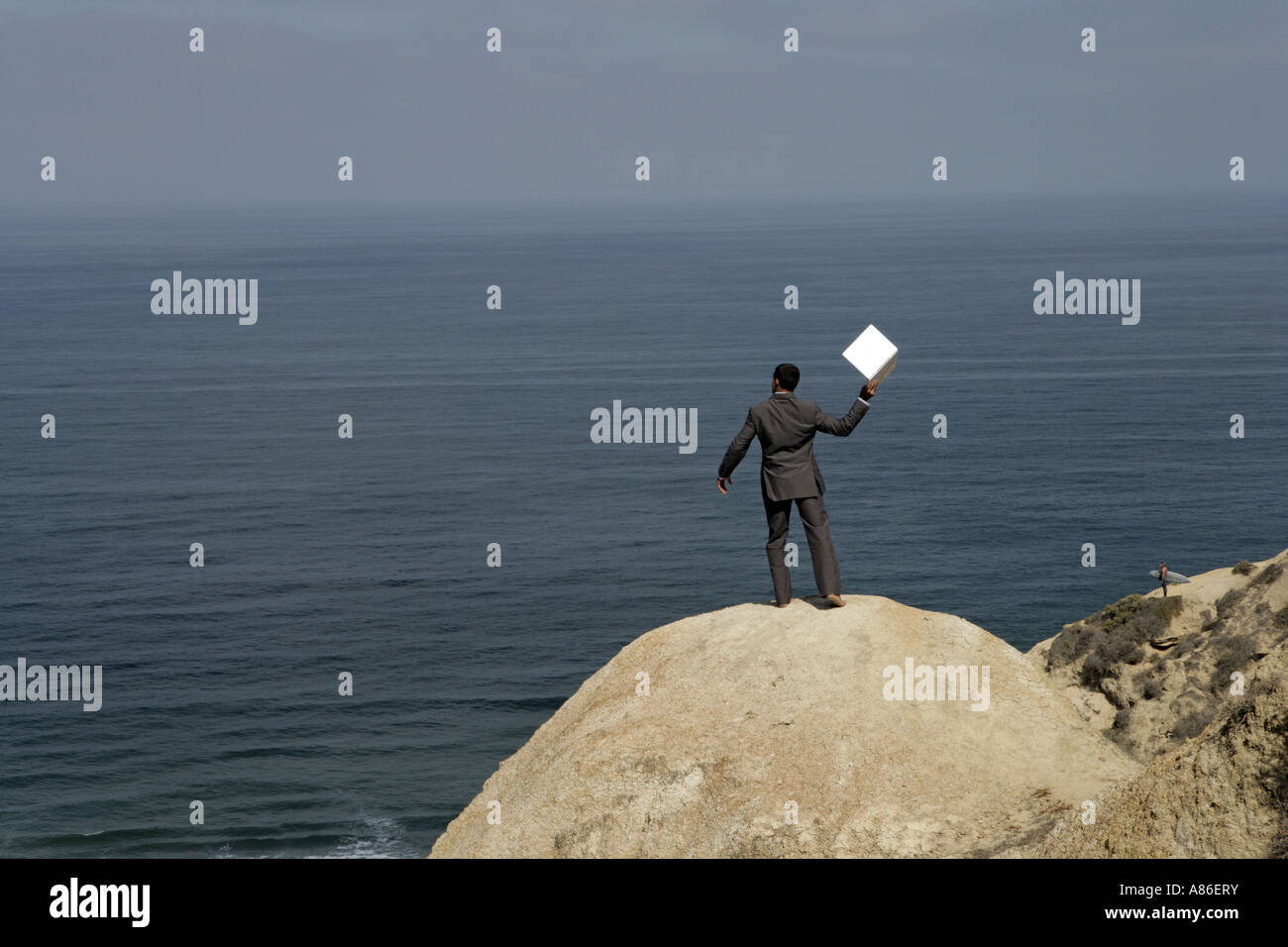 View of a man standing on a cliff Stock Photo - Alamy