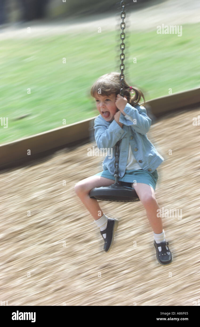 A young girl plays on a rope slide Stock Photo - Alamy