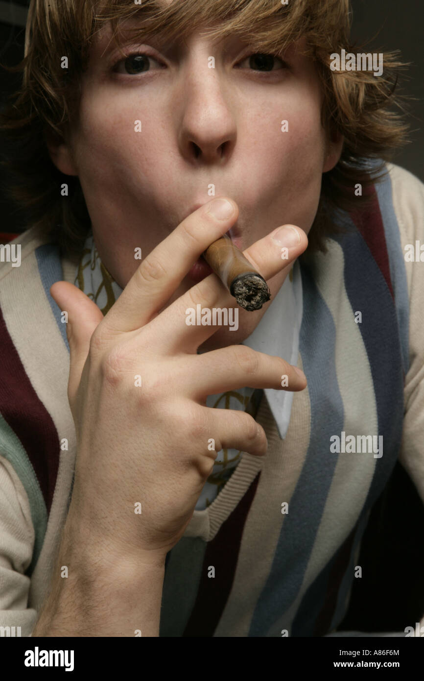Portrait of a young man smoking a cigar Stock Photo - Alamy
