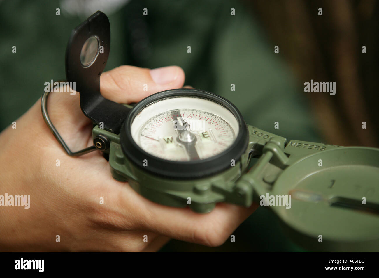 View of a person holding a compass Stock Photo - Alamy