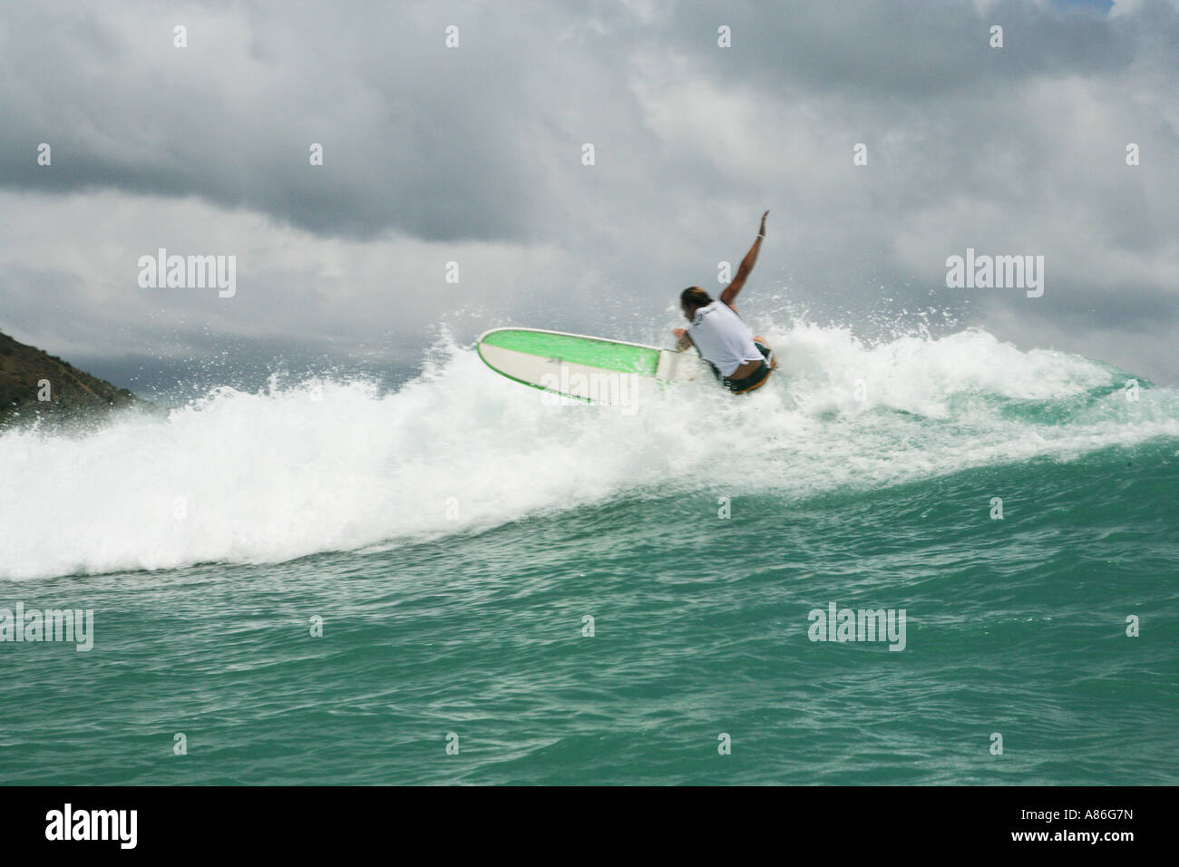 View of a surfer riding the waves Stock Photo - Alamy